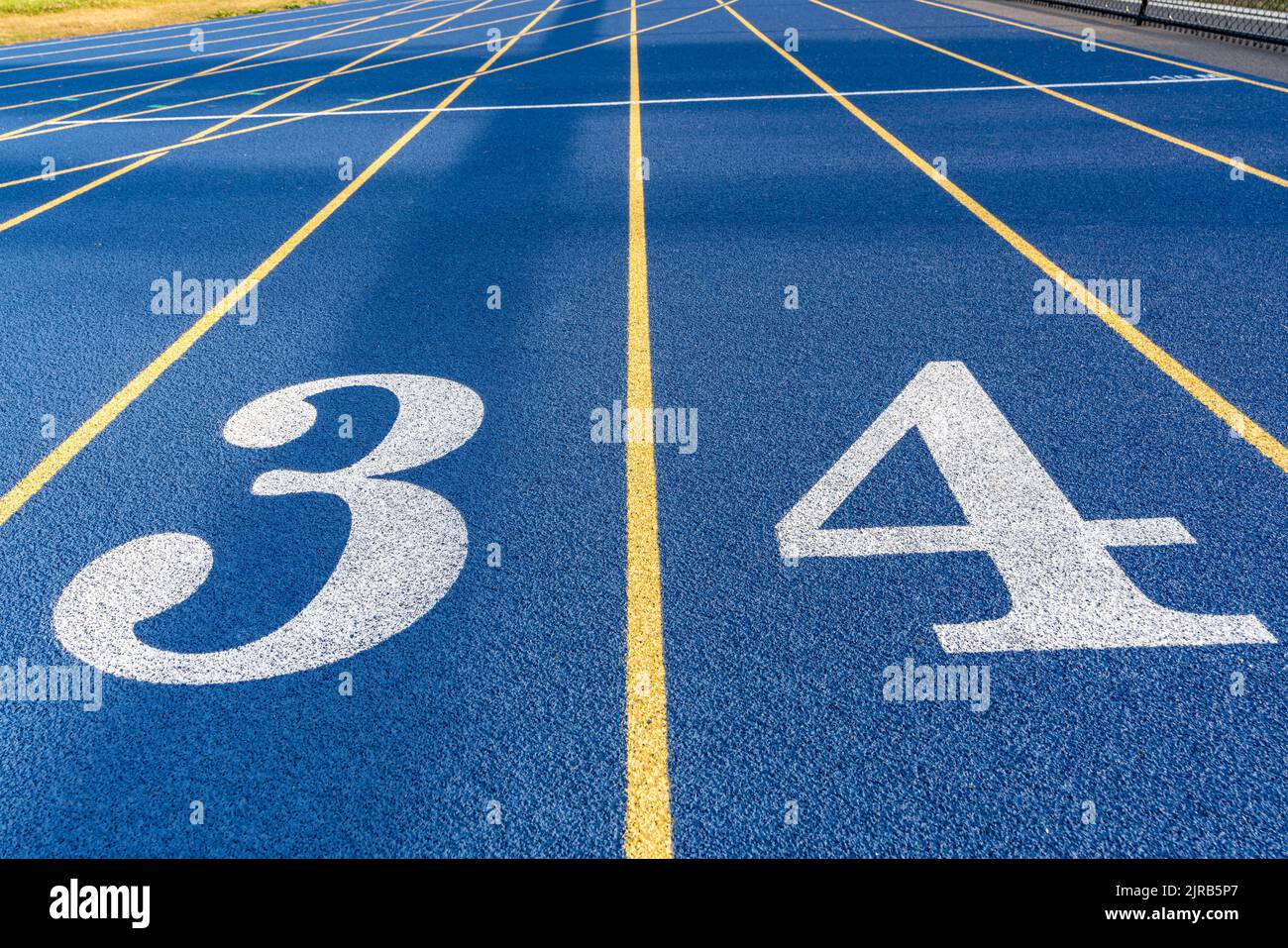 Close up of the middle two lanes, 3 and 4, on new blue running track ...