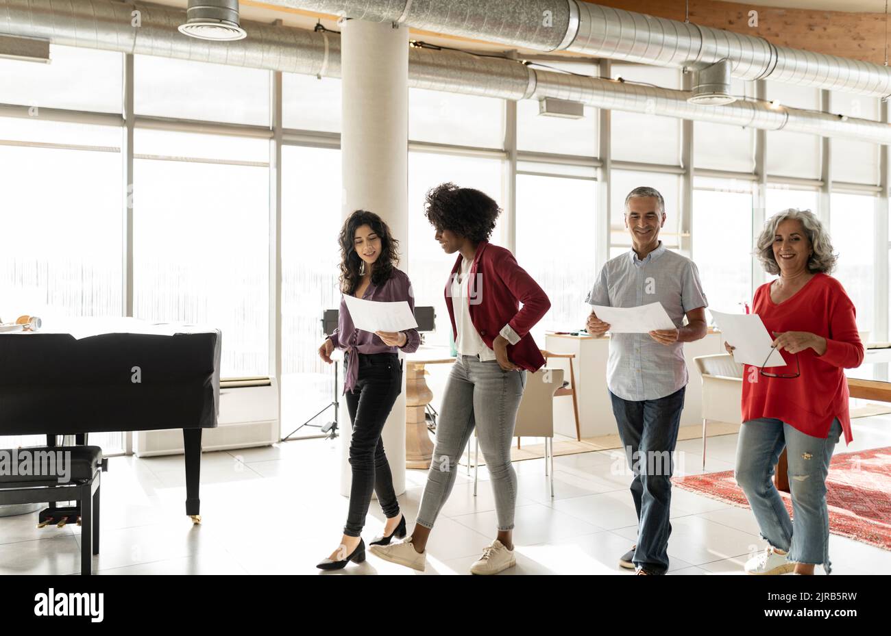 Businessman and businesswomen with documents walking in office Stock ...