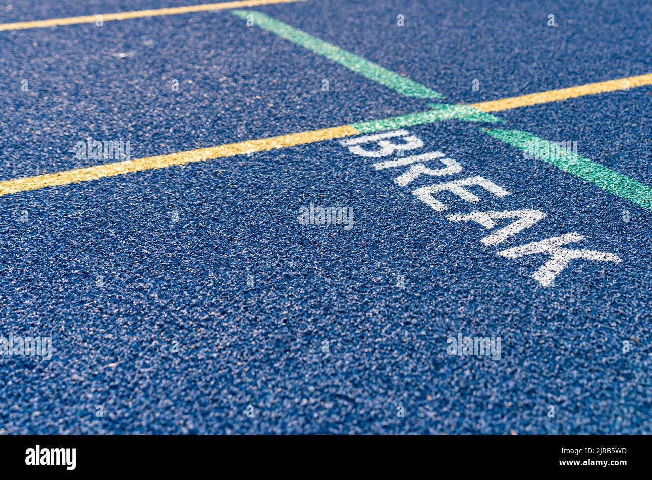 Inspiring close up of the break, transition on a new blue running track ...