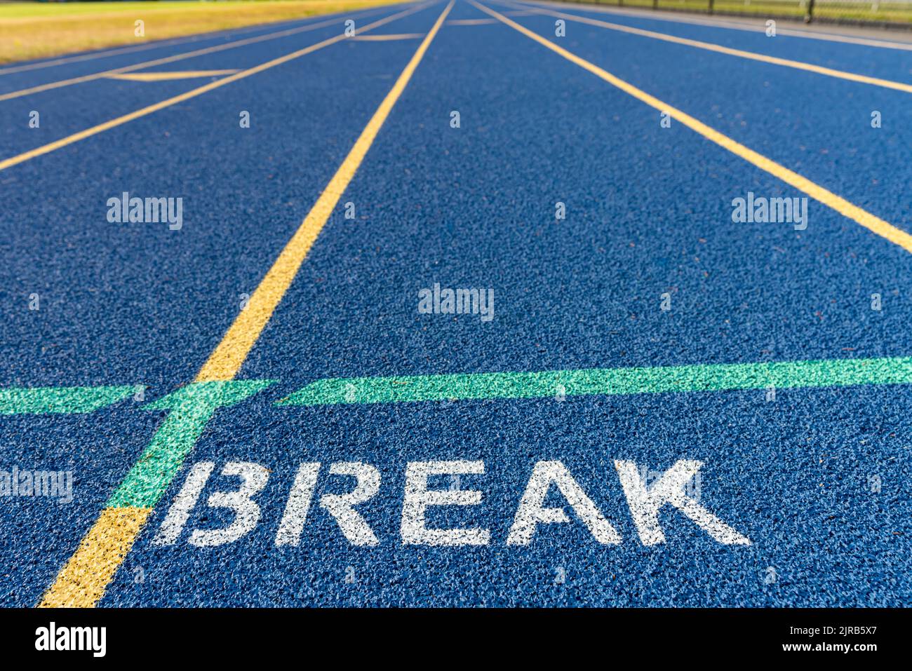 Inspiring close up of the break, transition on a new blue running track ...