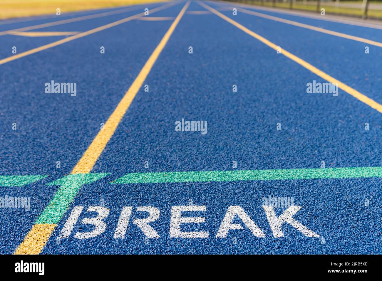 Inspiring close up of the break, transition on a new blue running track ...