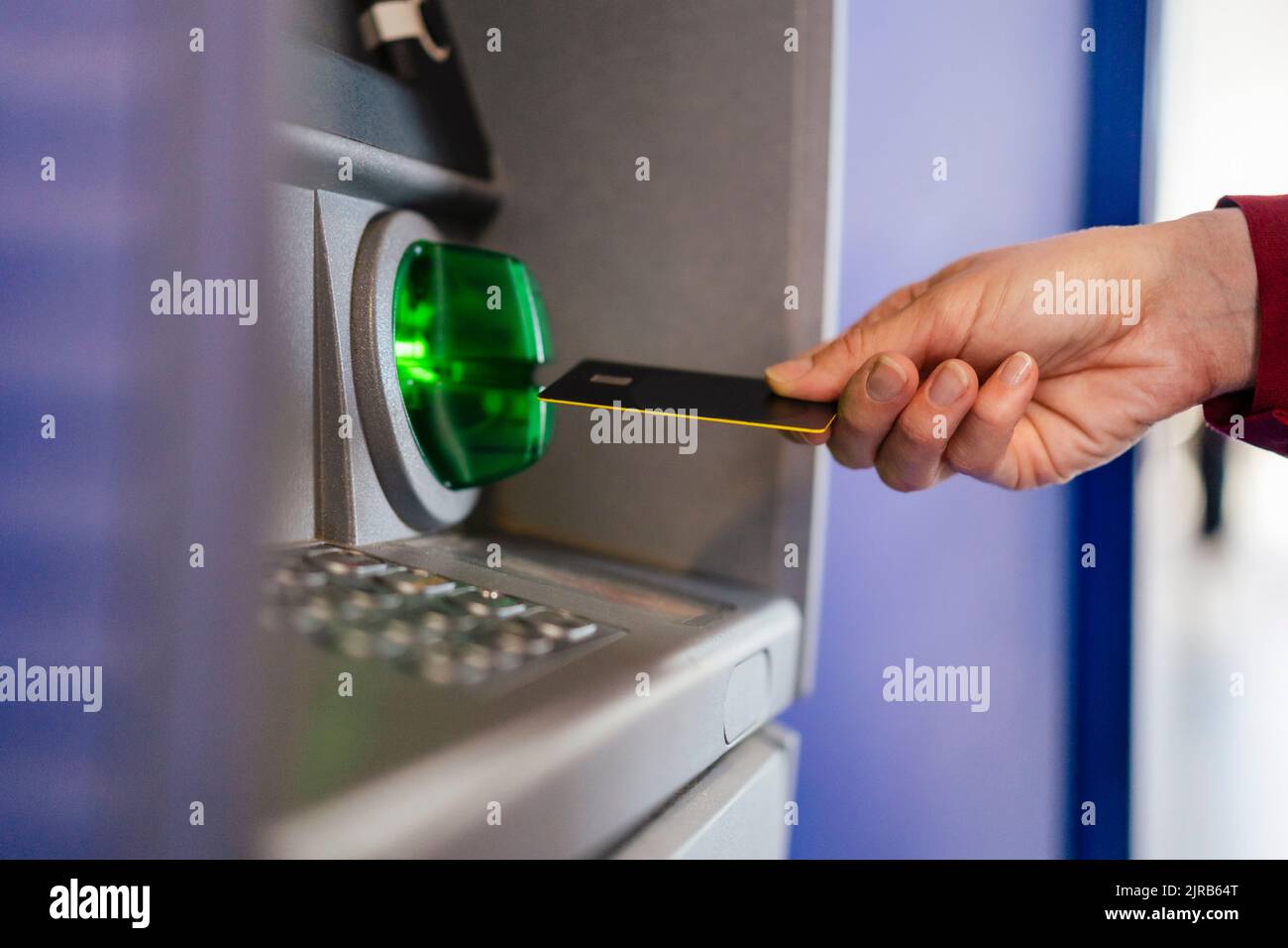 Woman's hand using credit card at ATM Stock Photo - Alamy