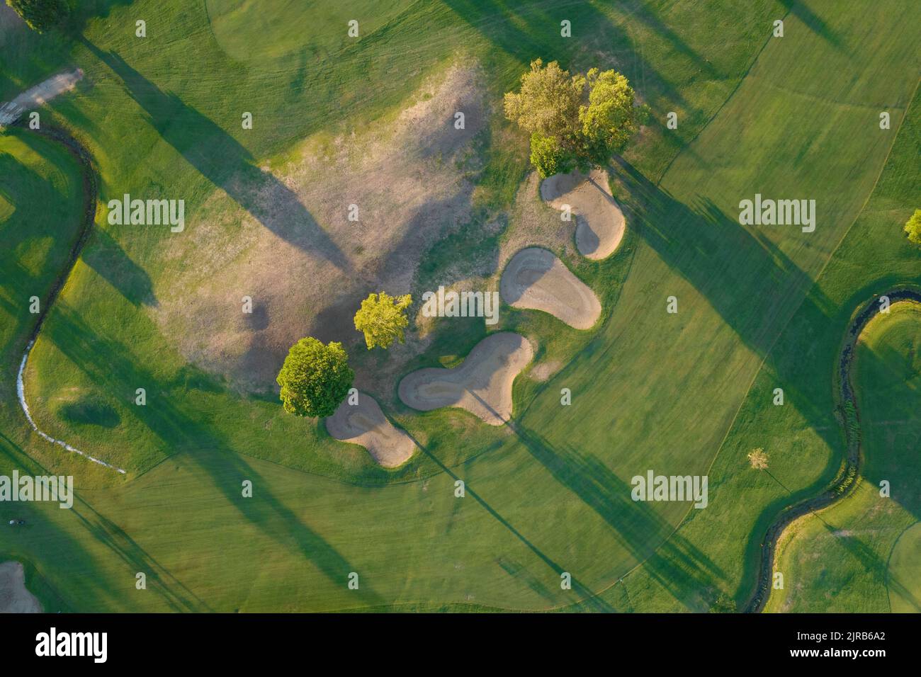 Aerial photographic documentation of a golf course taken at sunset ...