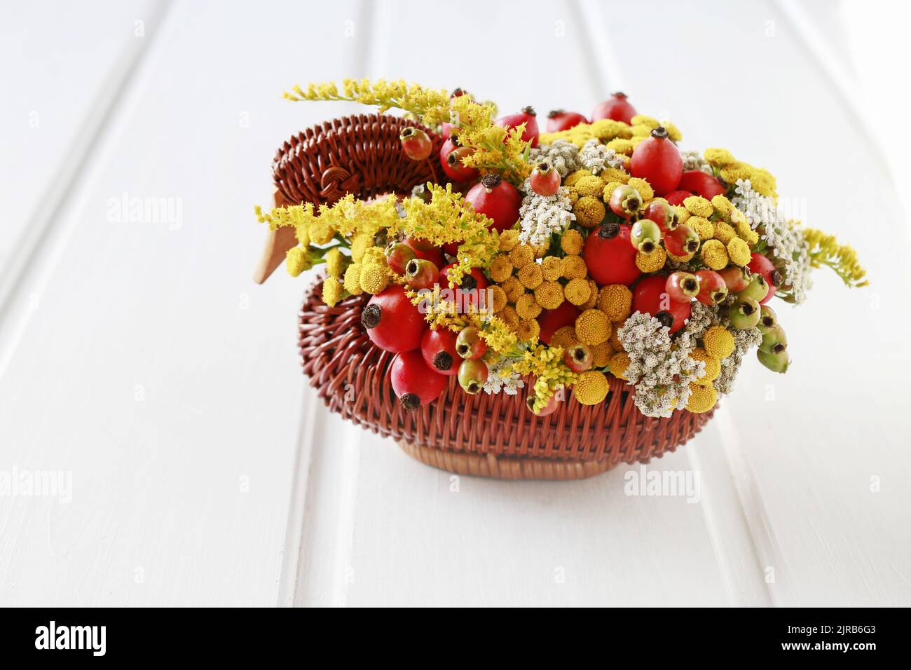 Bouquet of flowers in wicker goose. Table centerpiece idea for St ...