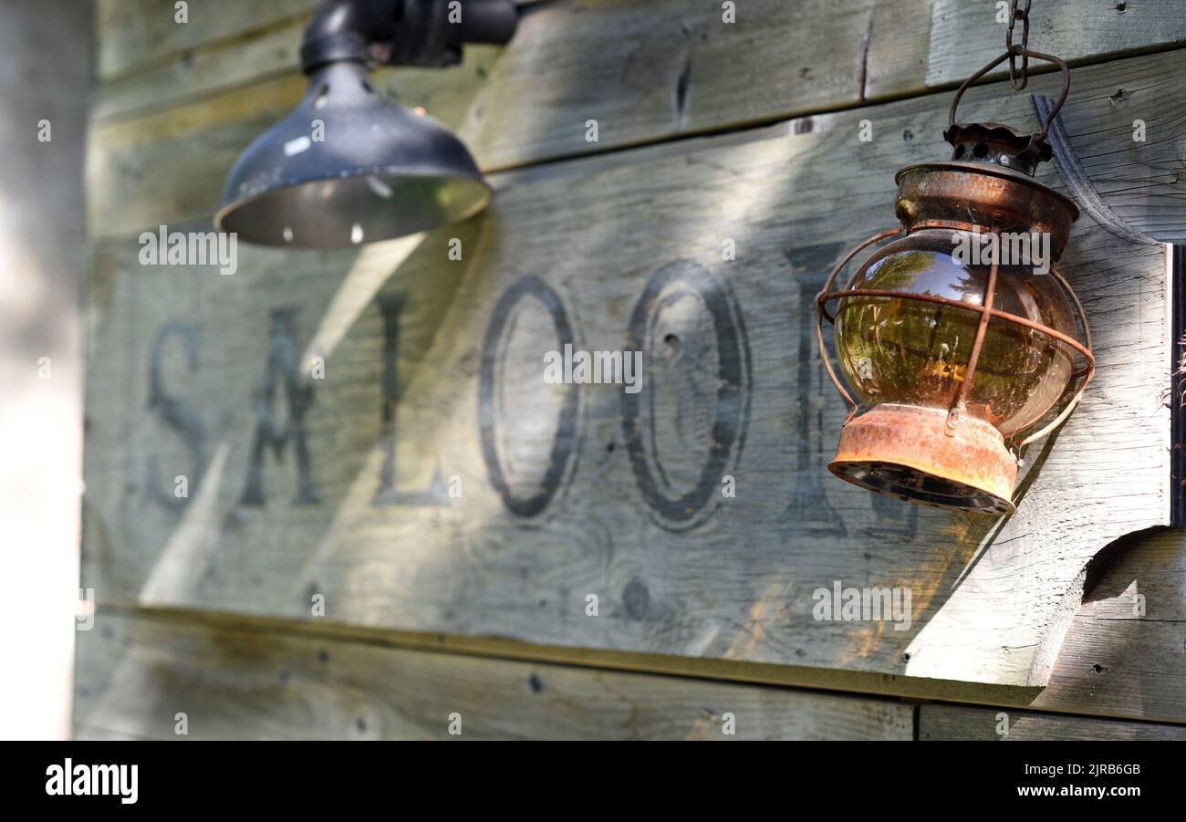 A selective focus shot of vintage lights on wooden signage with the ...