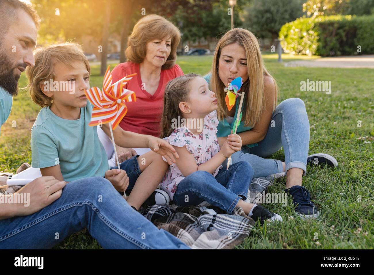 Family playing with pinwheels on picnic at park Stock Photo - Alamy