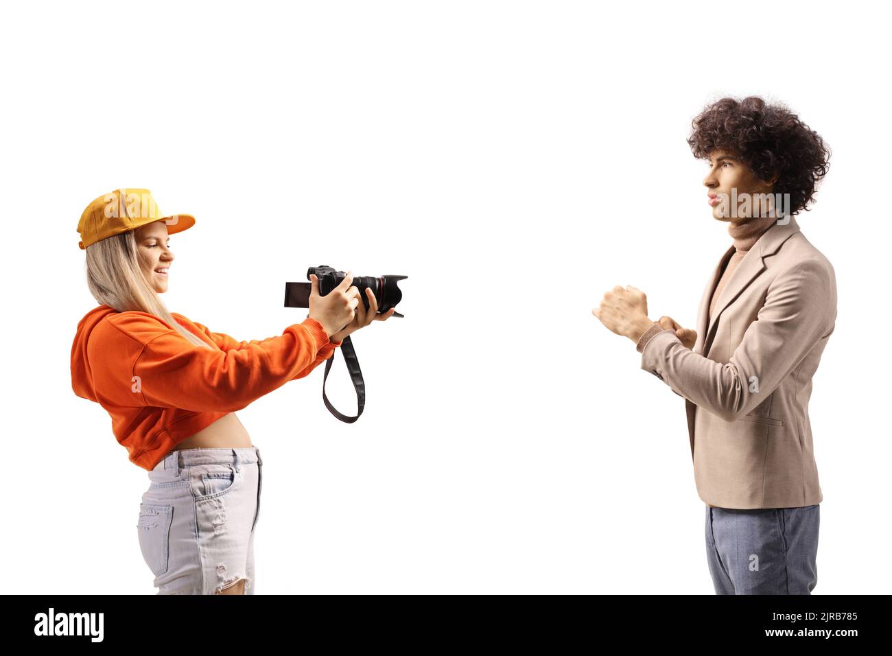 Young female photographer taking a photo of a male model isolated on ...