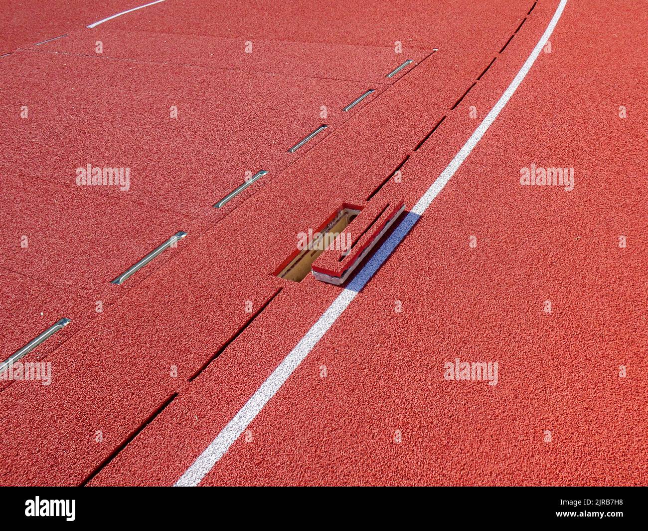 Example of a new running track with slot drain cleanout with cover ...