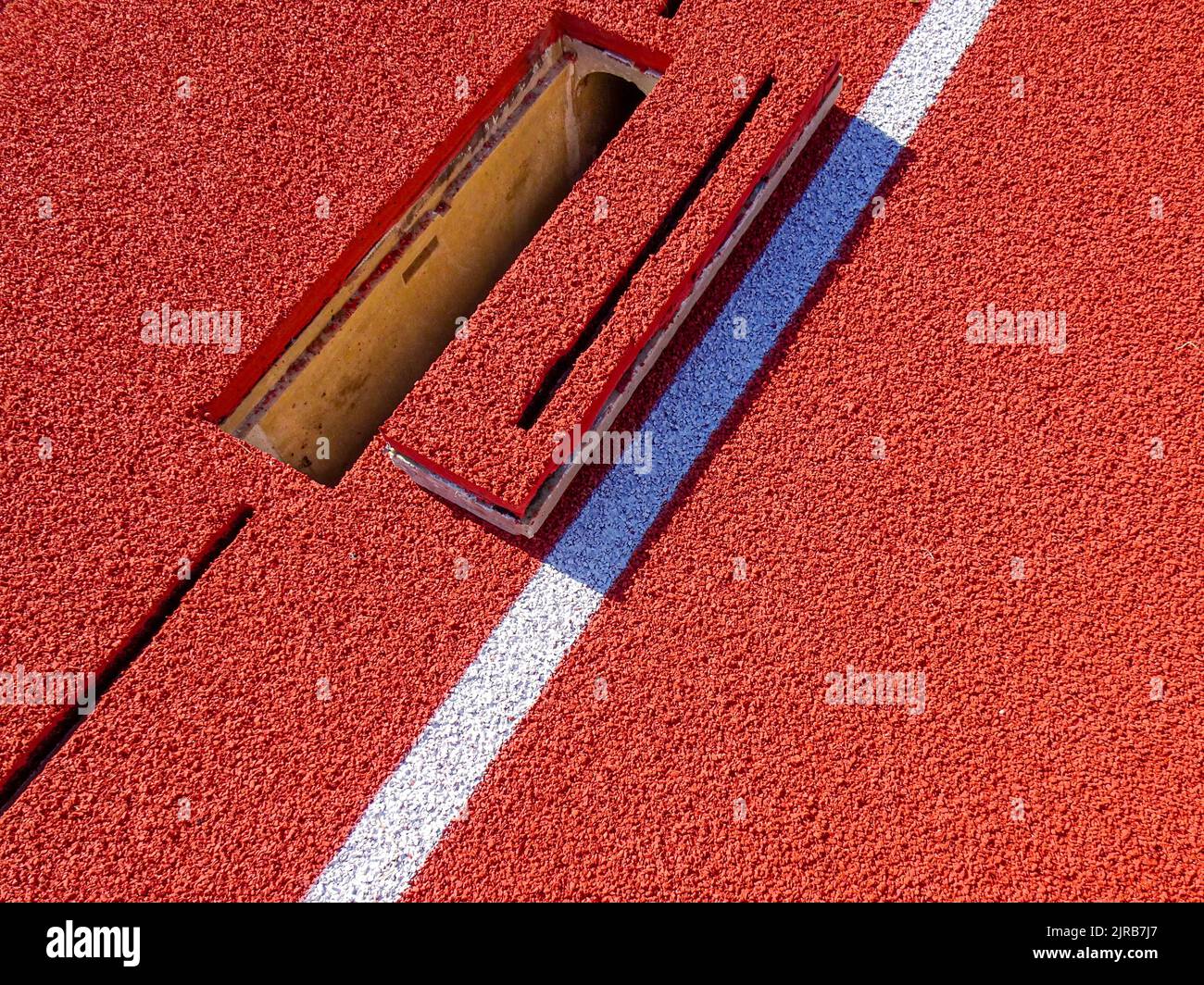 Example of a new running track with slot drain cleanout with cover ...