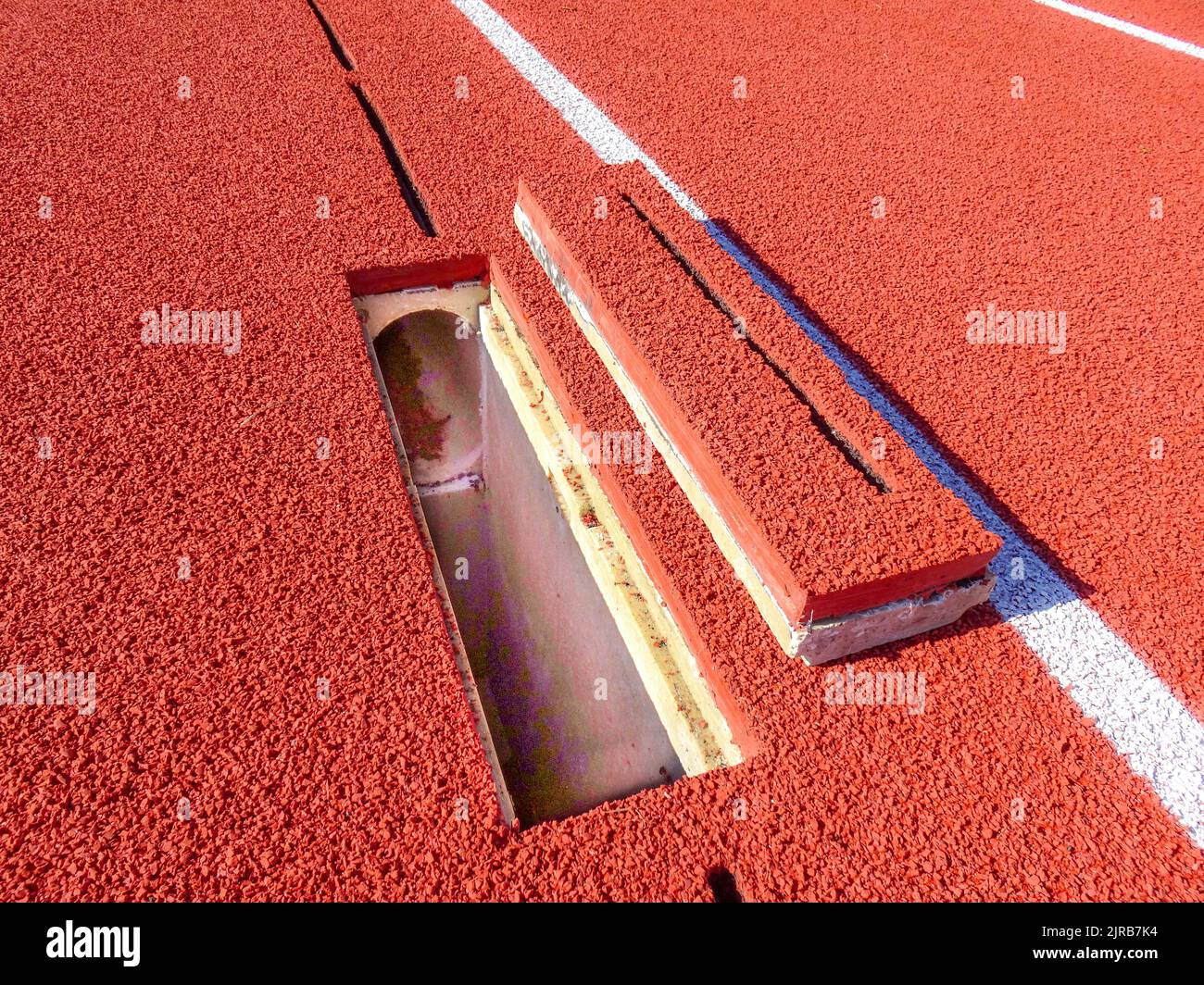 Example of a new running track with slot drain cleanout with cover ...