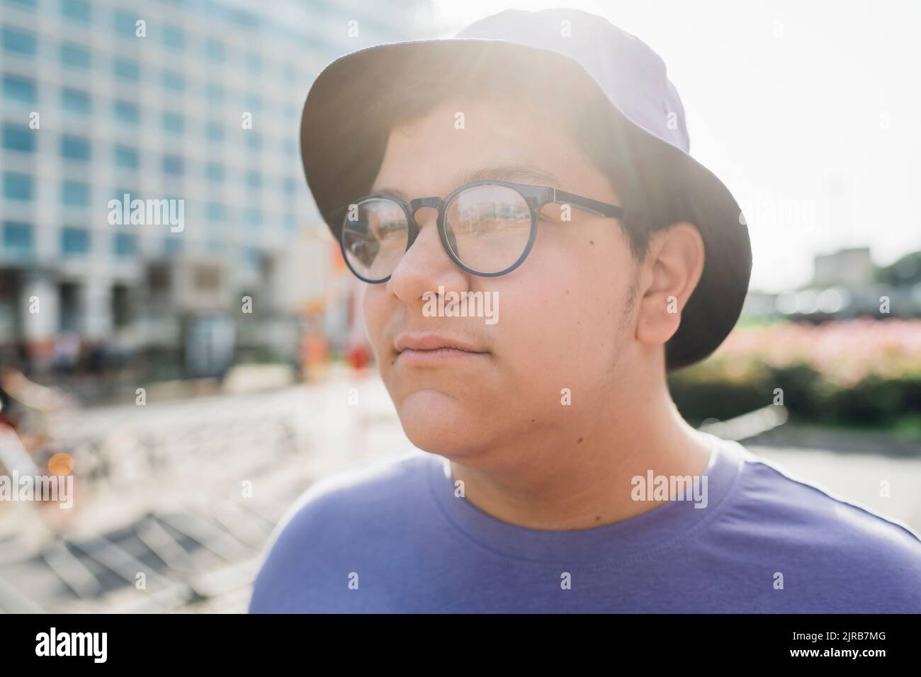 Thoughtful teenage boy with eyeglasses on sunny day Stock Photo - Alamy
