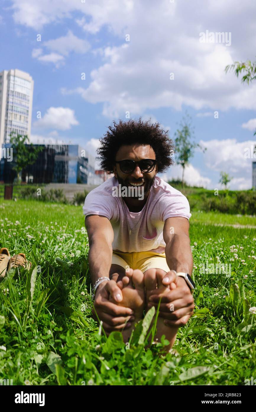 Man stretching on grass hi-res stock photography and images - Alamy