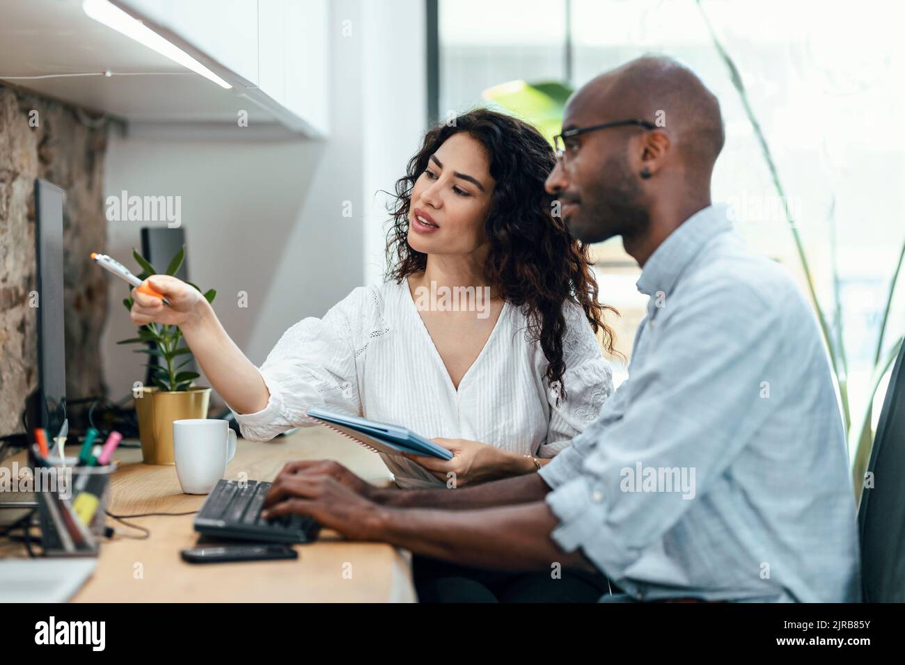 Business people pointing at monitor hi-res stock photography and images ...