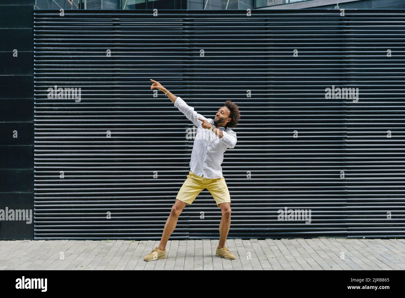 Man dancing in front of wall Stock Photo - Alamy