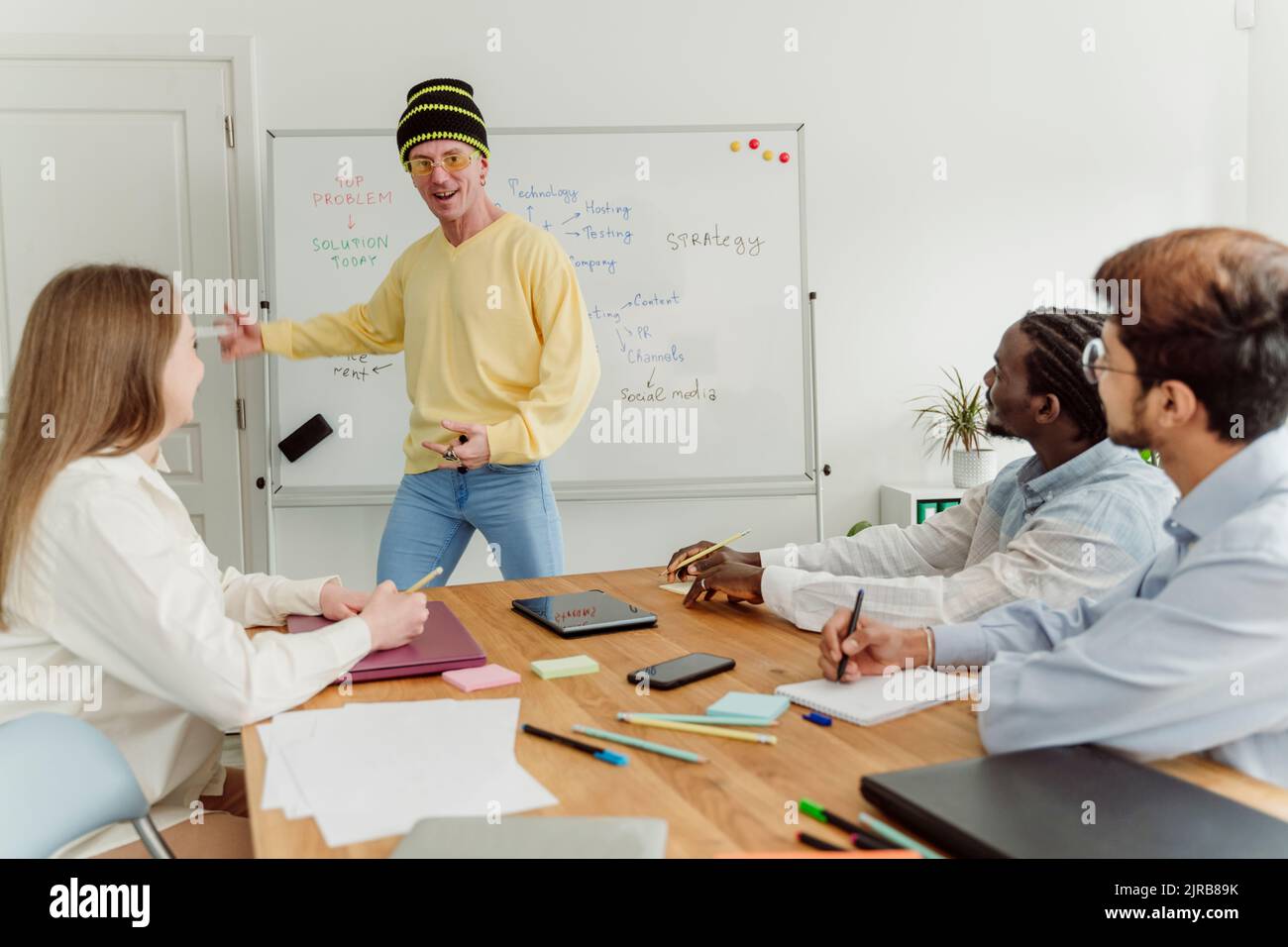 Happy businessman giving presentation to colleague at office Stock ...