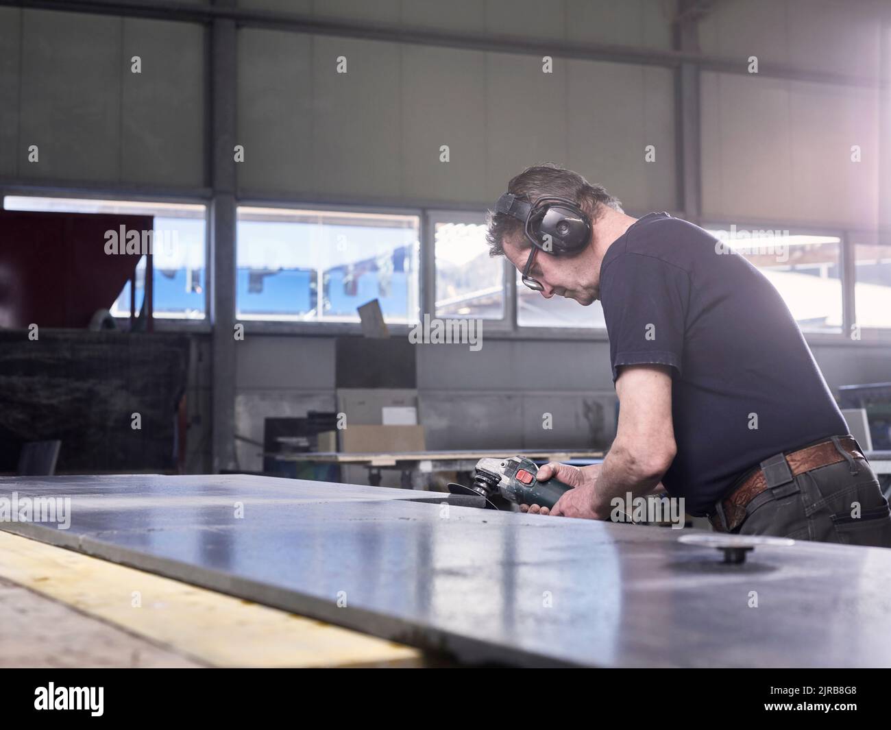 Stonemason shaping marble slab with grinder at workshop Stock Photo - Alamy