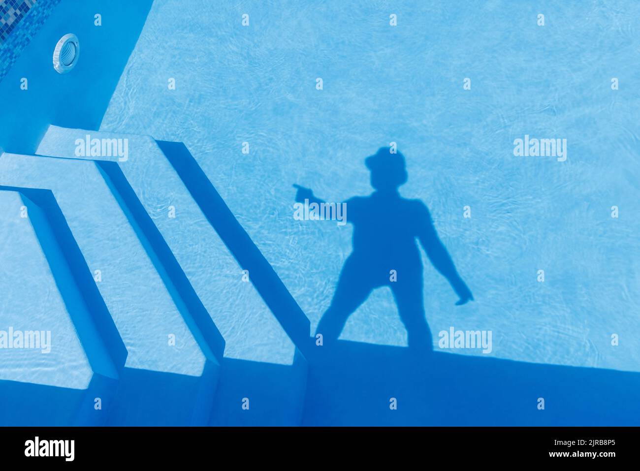 Shadow of man seen on water of swimming pool Stock Photo - Alamy