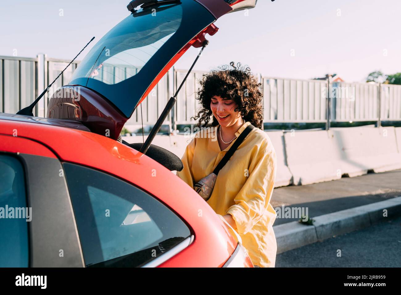 Young woman opening trunk car hi-res stock photography and images - Alamy