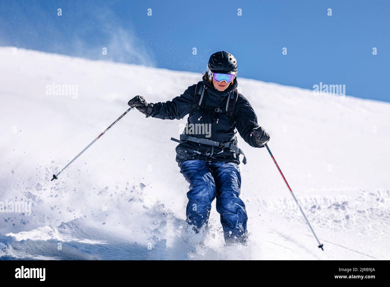 Woman sking on snowy slope Stock Photo - Alamy