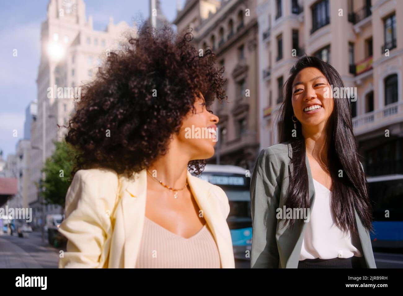 Happy multiracial friends talking to each other Stock Photo - Alamy