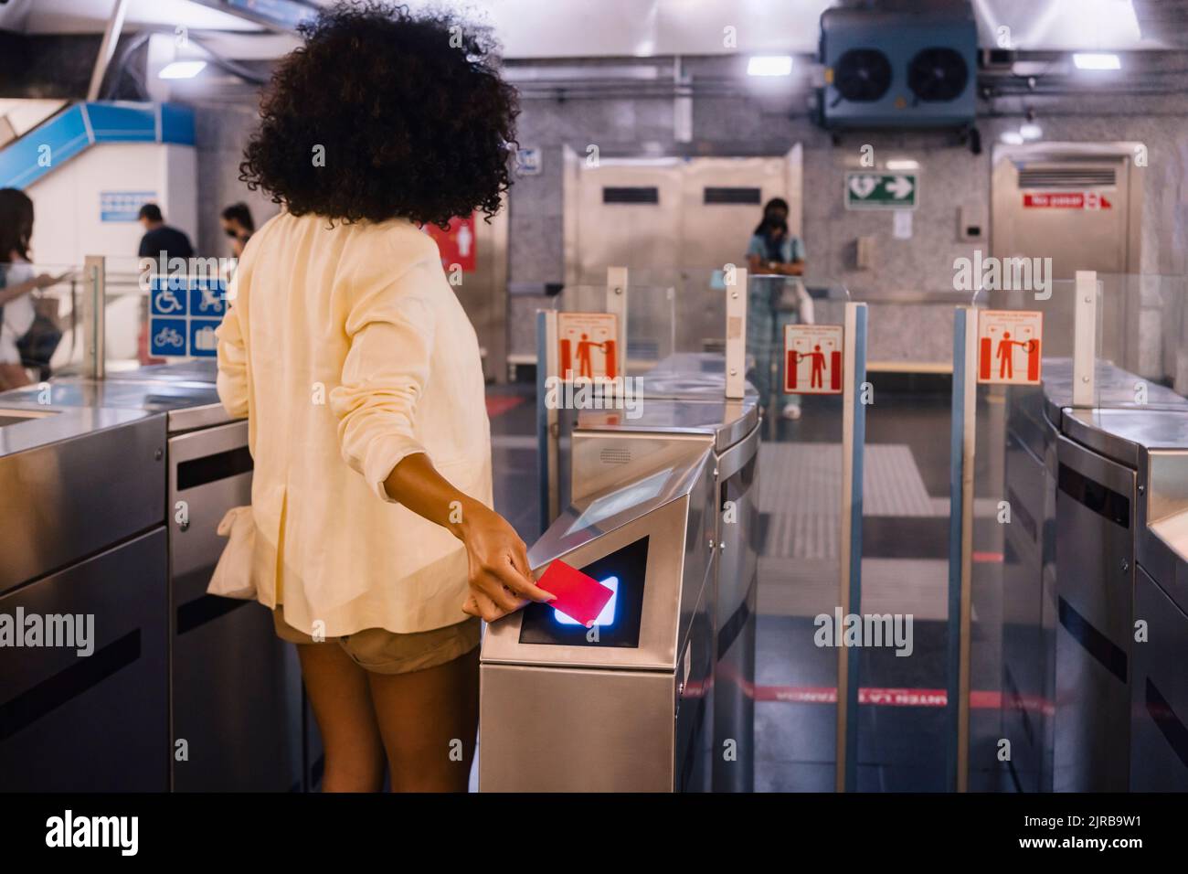 Woman scanning ticket on turnstile at subway station Stock Photo - Alamy