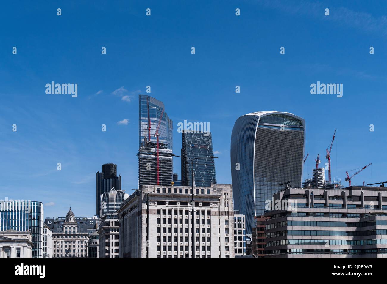 Skyscrapers under blue sky on sunny day in London, England Stock Photo ...