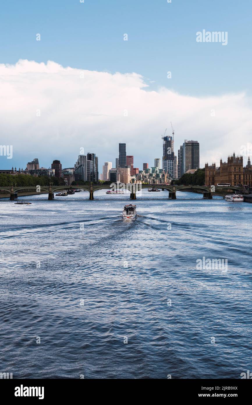 London skyline with Thames River under cloudy sky, England Stock Photo ...