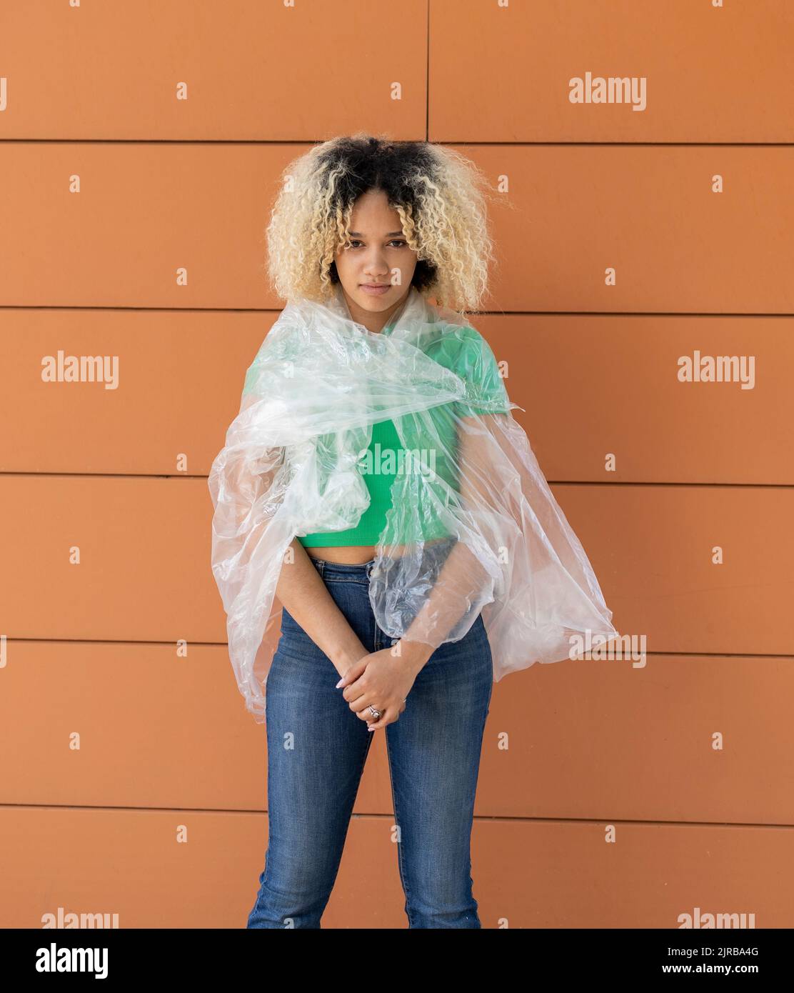 Young woman with Afro hairstyle wrapped in plastic Stock Photo - Alamy