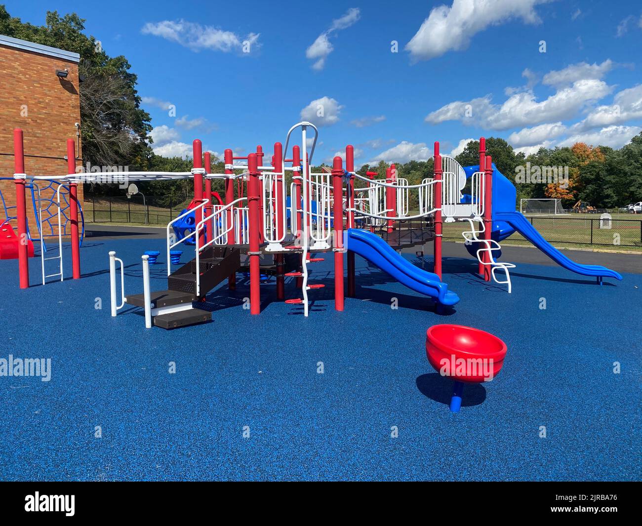 Unidentified typical elementary school playground with blue rubber ...