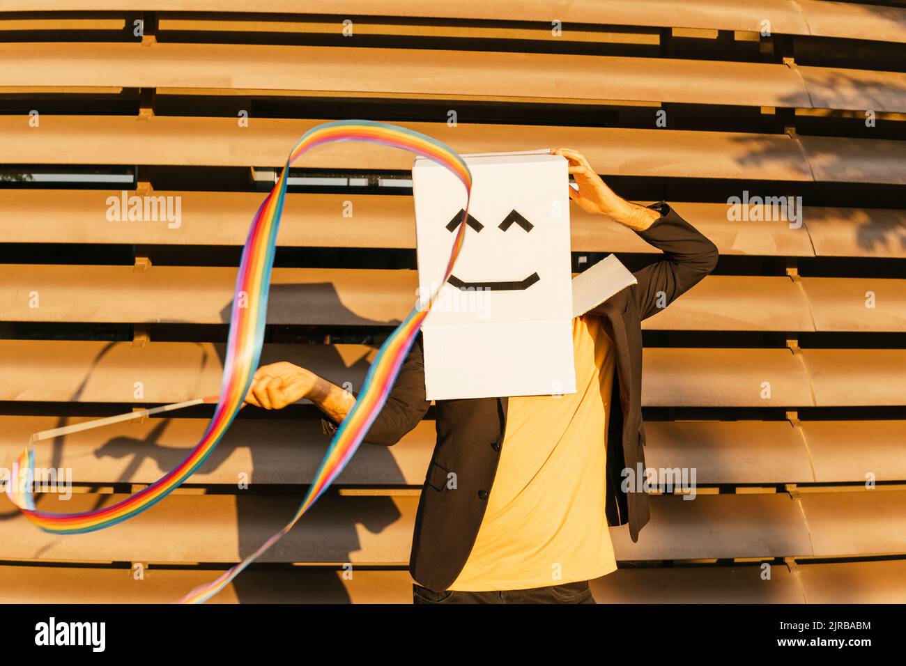 Man in smiley face box spinning rainbow colored rhythmic gymnastics ...