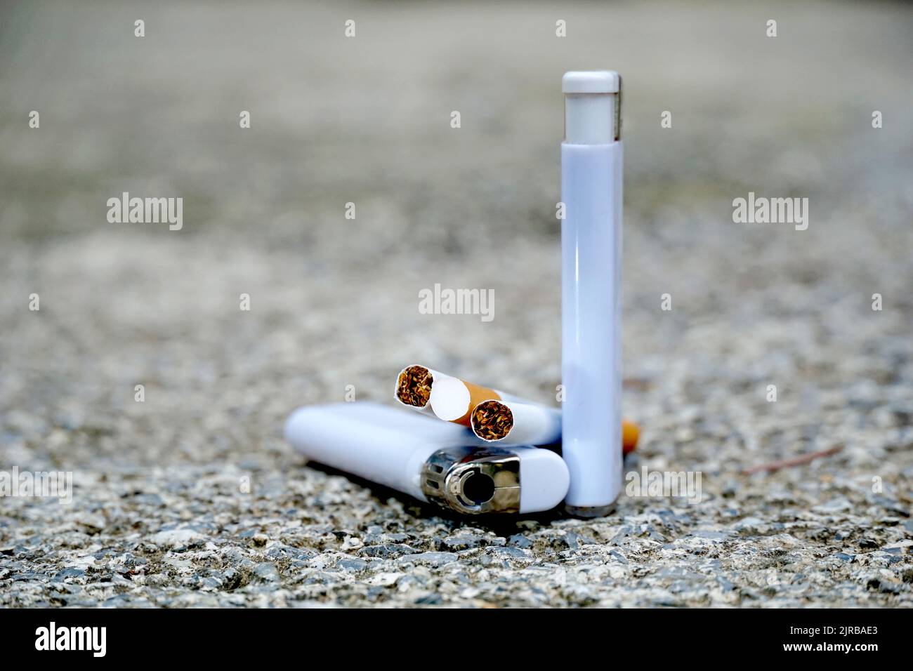 Cigarettes and Lighter Close Up On a Concrete background Stock Photo ...