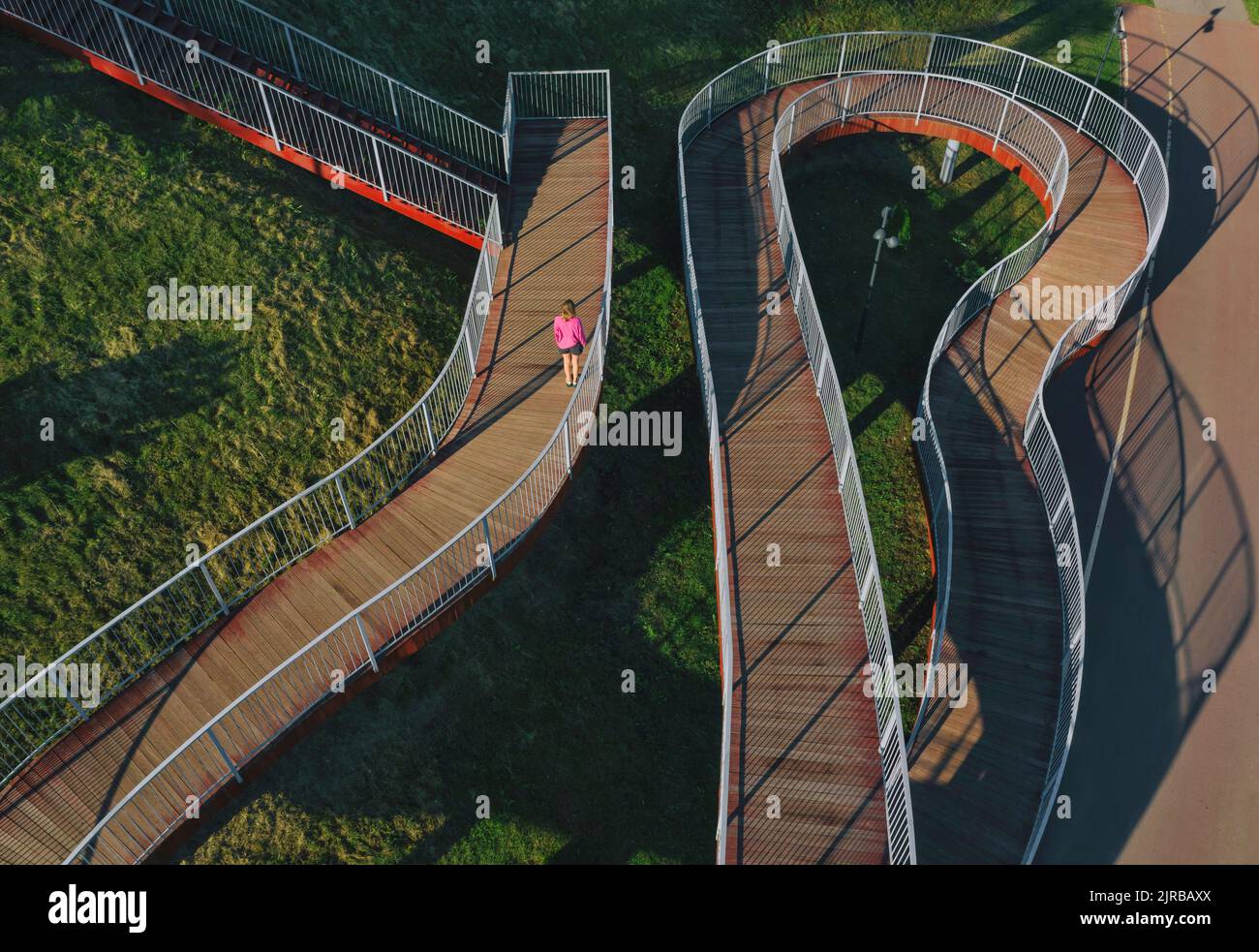 Russia, Aerial view of woman standing on winding boardwalk Stock Photo ...