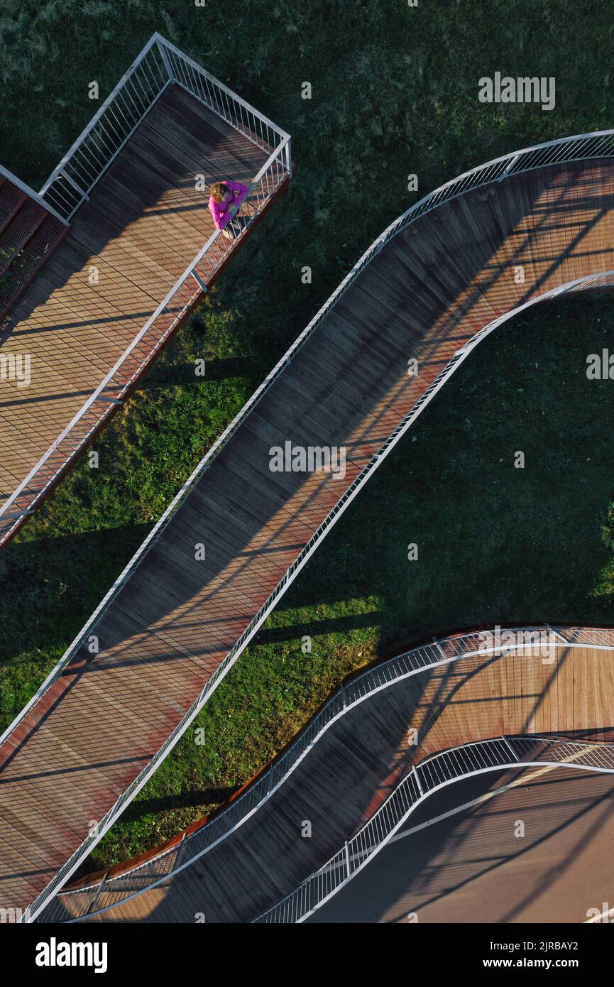 Russia, Aerial view of woman standing on winding boardwalk Stock Photo ...
