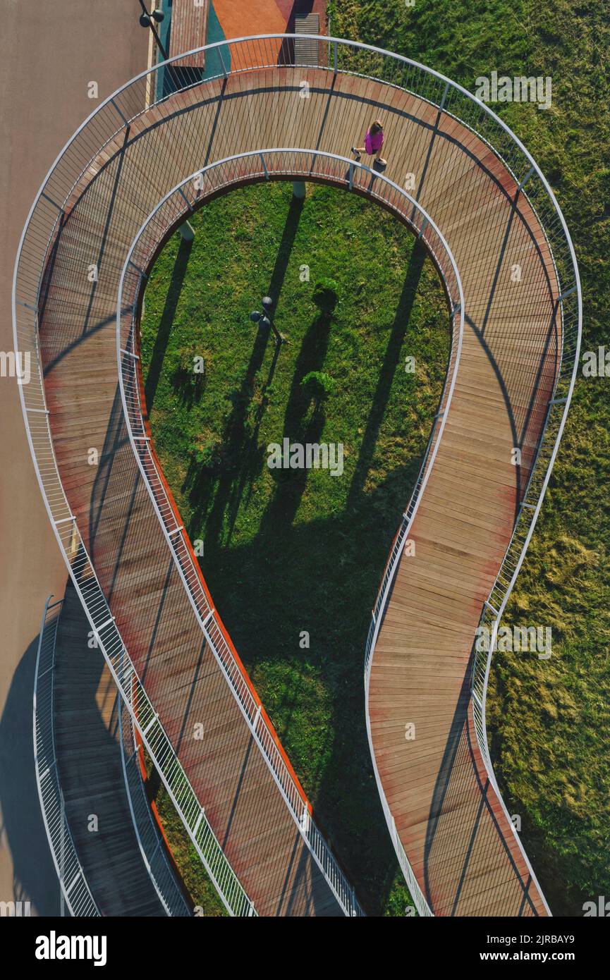 Russia, Aerial view of woman walking along winding boardwalk Stock ...