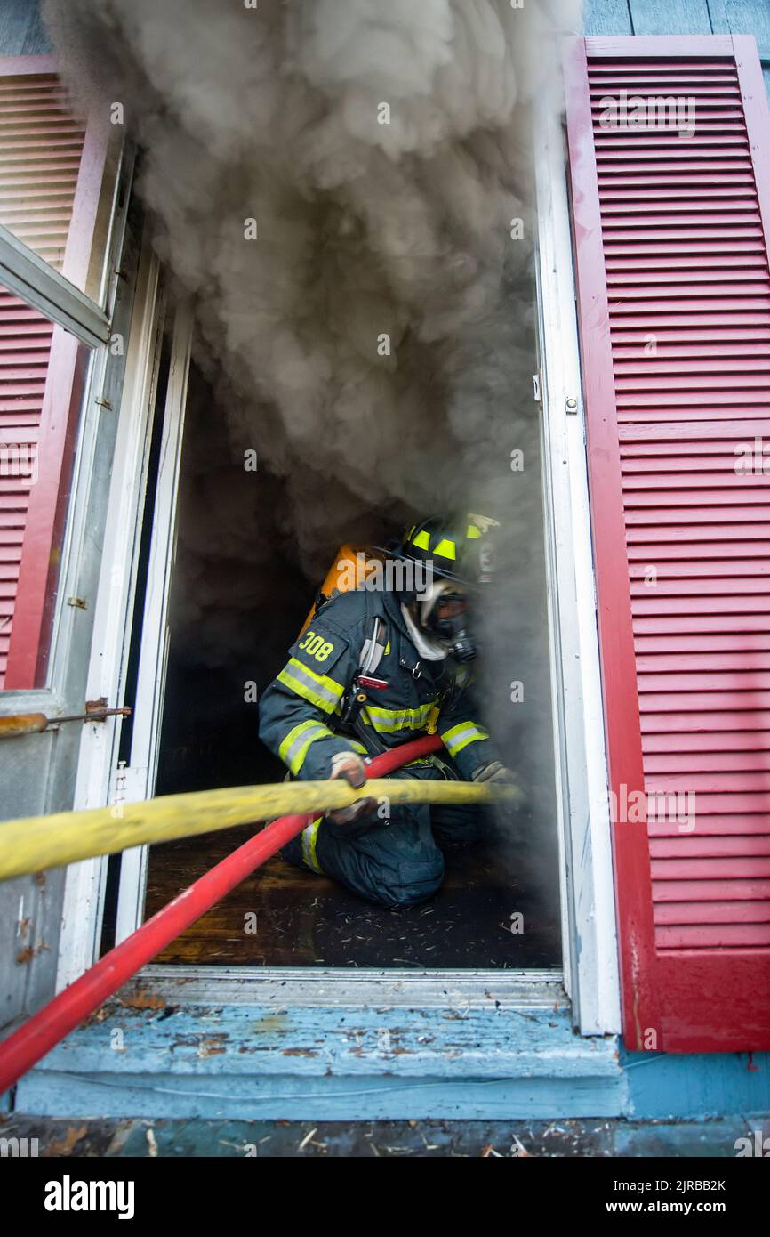 A Sag Harbor Fire Department firefighter wearing breathing apparatus ...