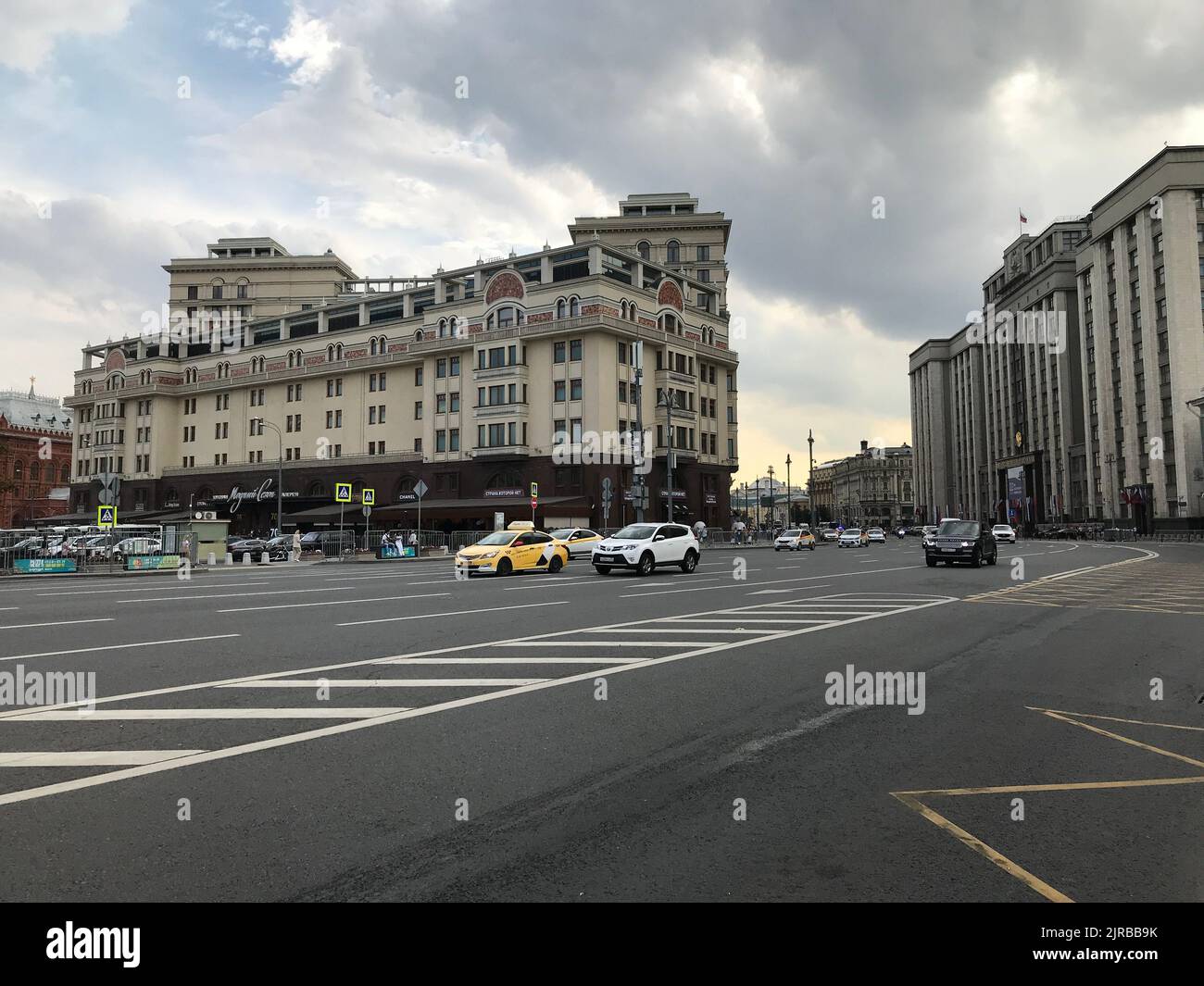 An aerial view or cars driving on road surrounded by buildings in ...