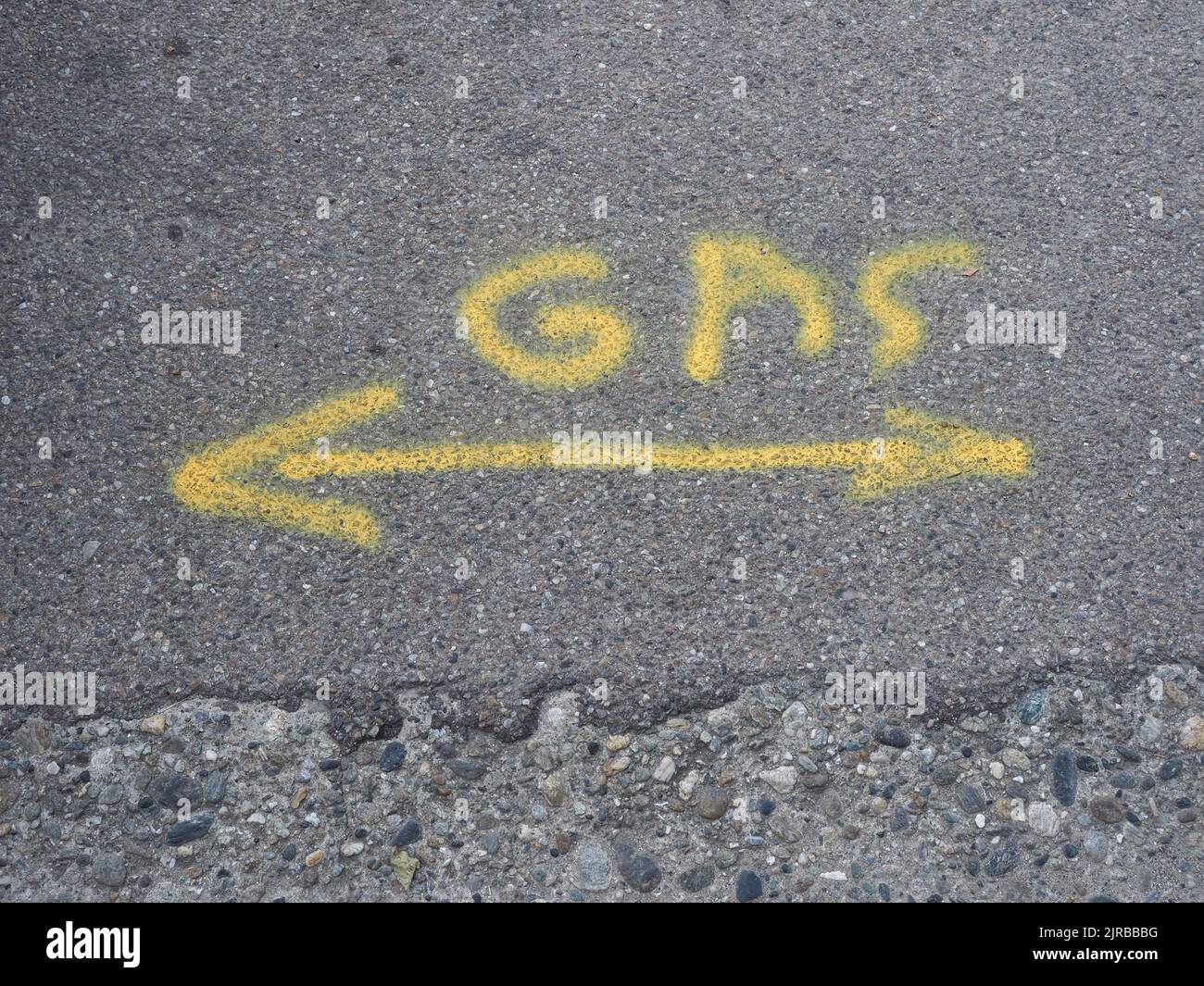 gas pipe arrow sign painted on tarmac Stock Photo - Alamy