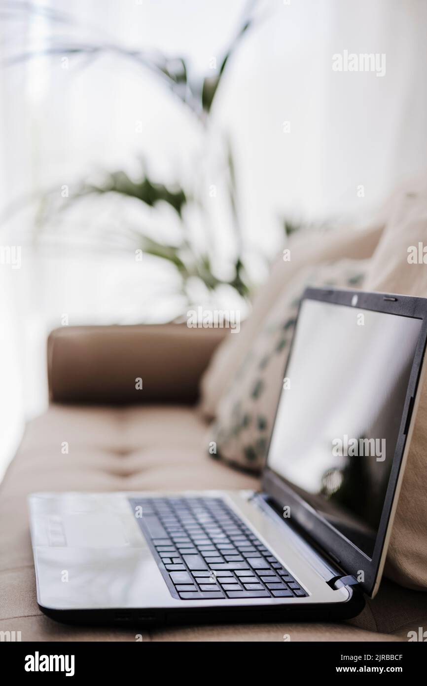 Laptop kept on sofa at home Stock Photo - Alamy