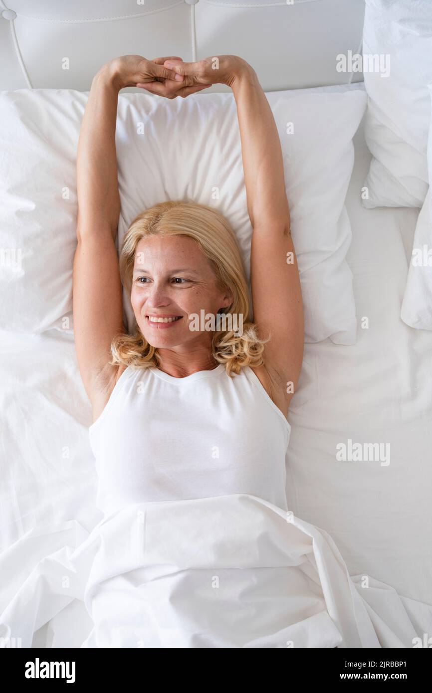 Woman stretching bed hi-res stock photography and images - Alamy