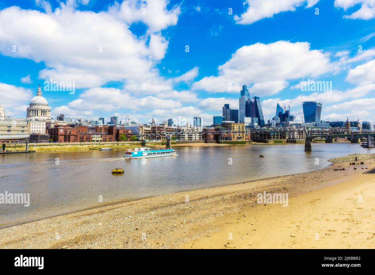 UK, England, London, Sandy bank of river Thames with city skyline in ...