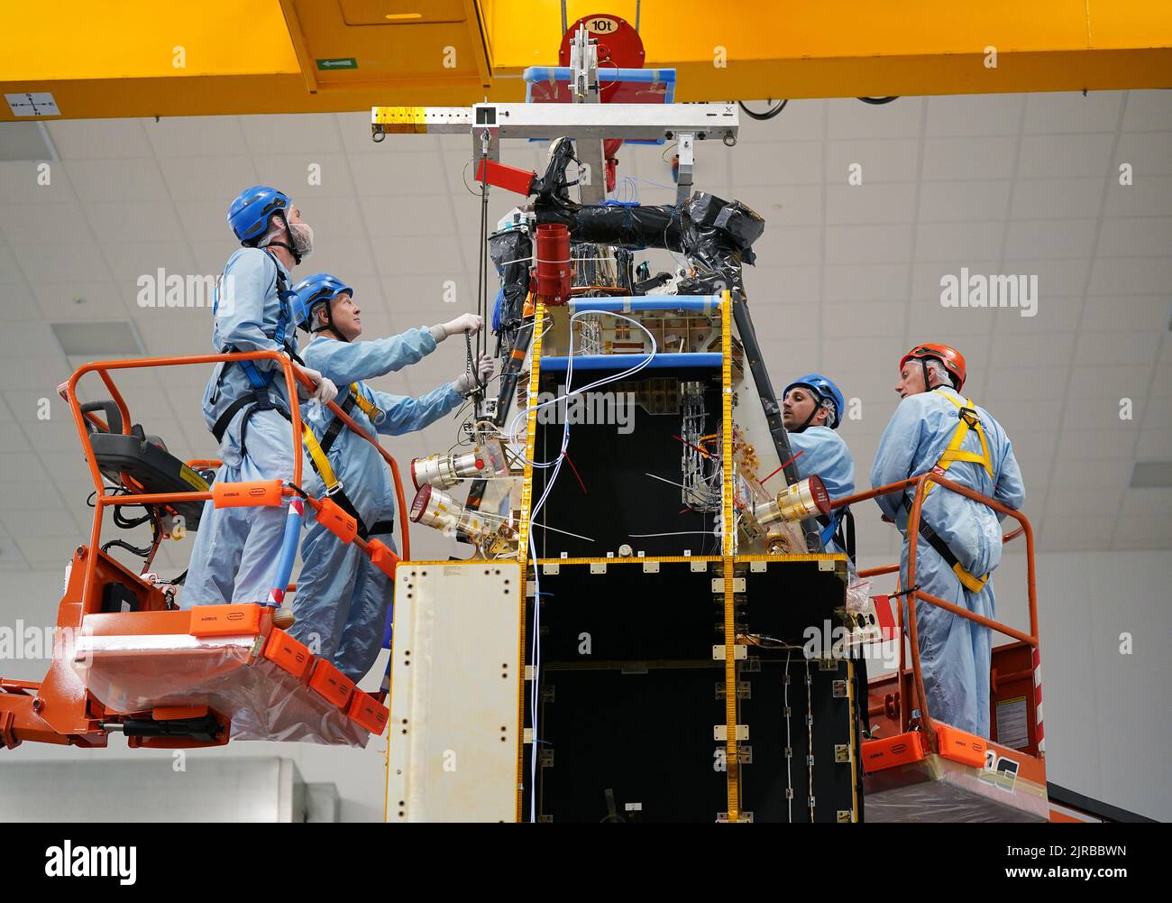 Members of staff work on the Biomass satellite at the Airbus factory in ...