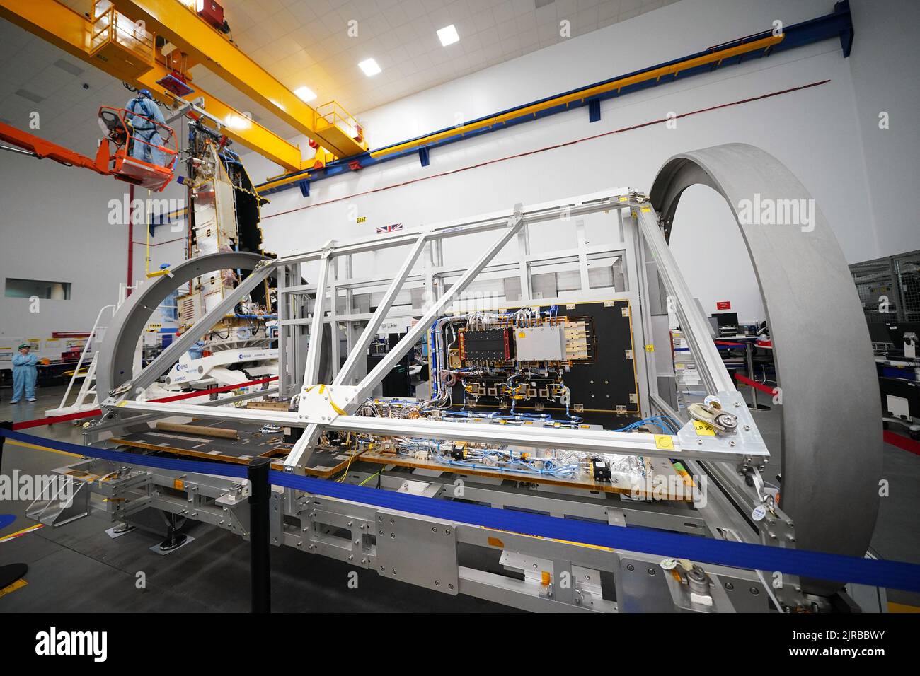 Members of staff work on the Biomass satellite at the Airbus factory in ...