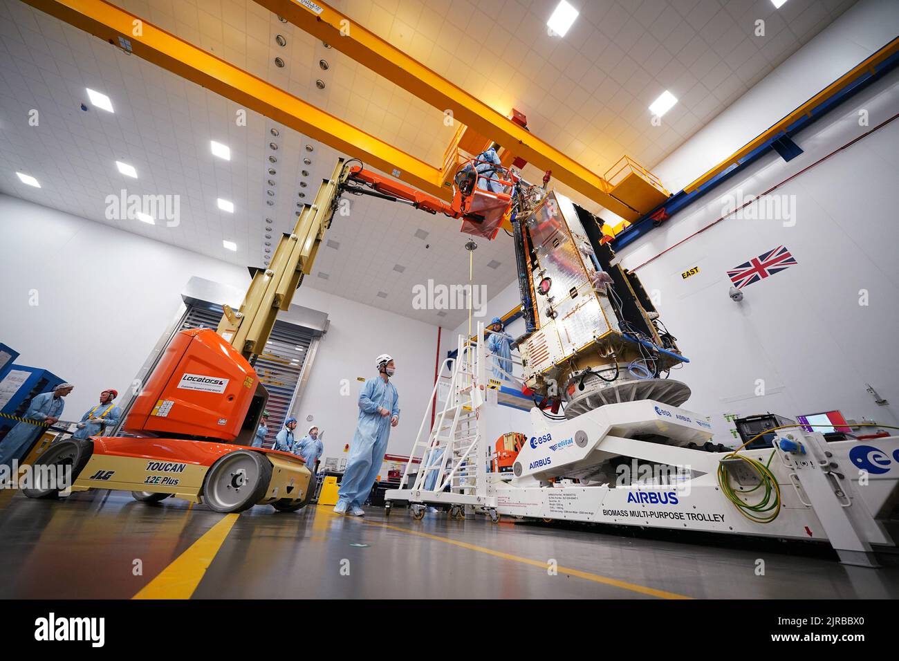Members of staff work on the Biomass satellite at the Airbus factory in ...