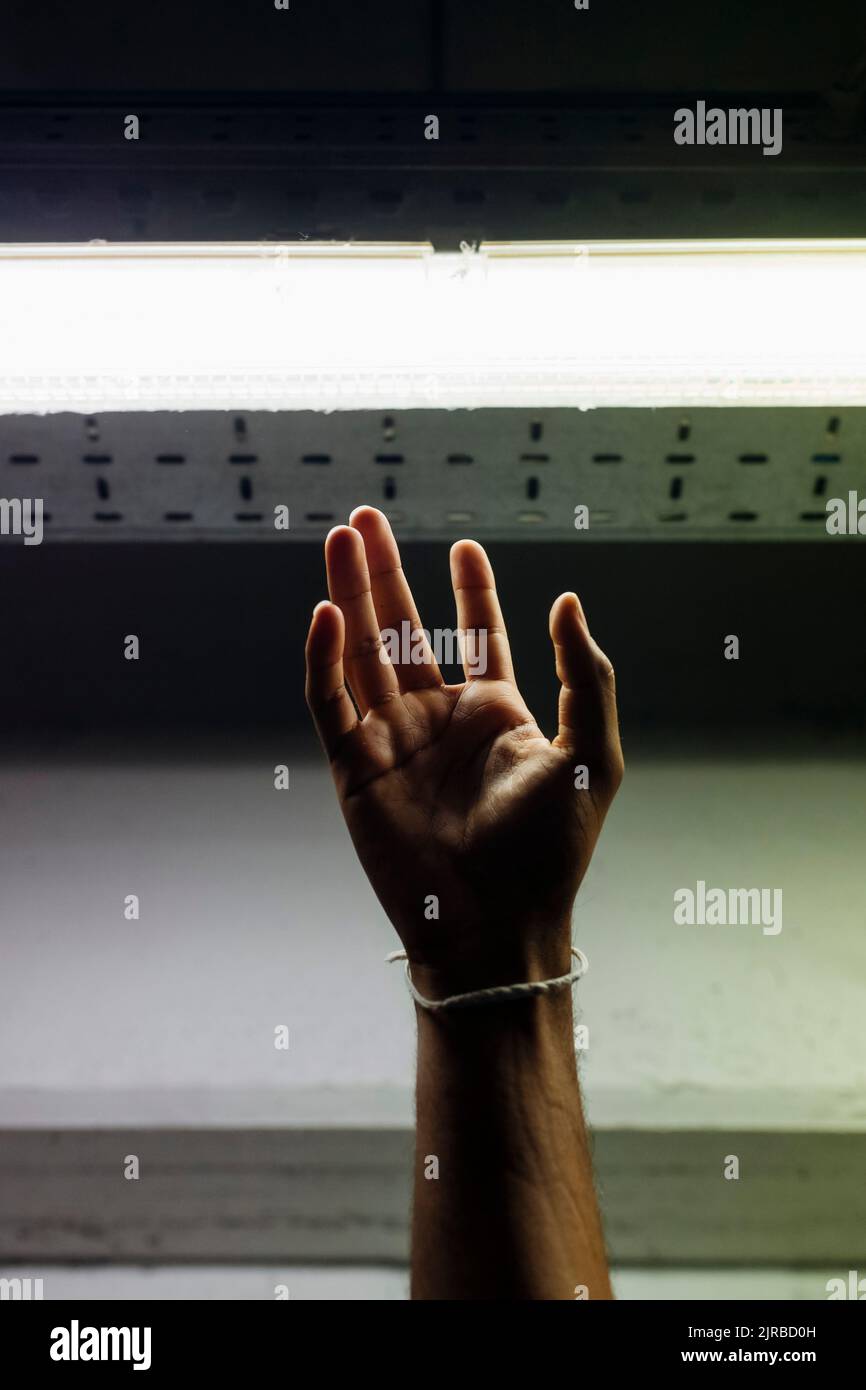 Hand of man reaching for LED light in subway Stock Photo - Alamy
