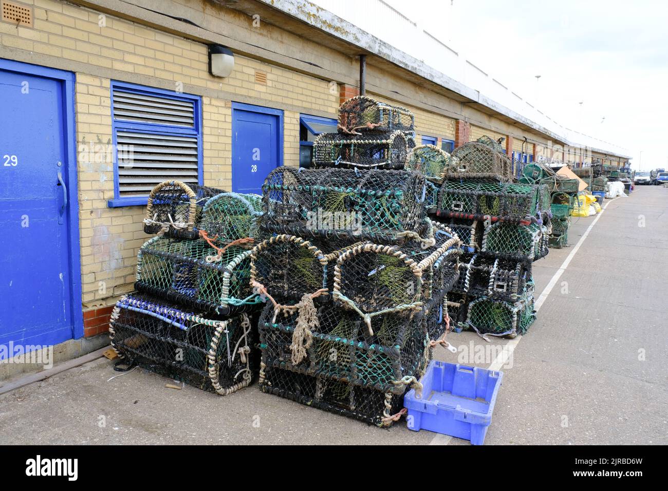 Fishing creels line the harbour side in the Yorkshire resort of ...