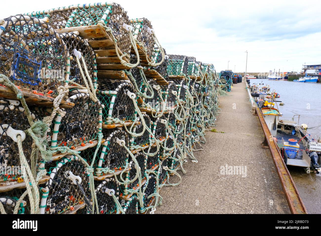 Fishing creels line the harbour side in the Yorkshire resort of ...