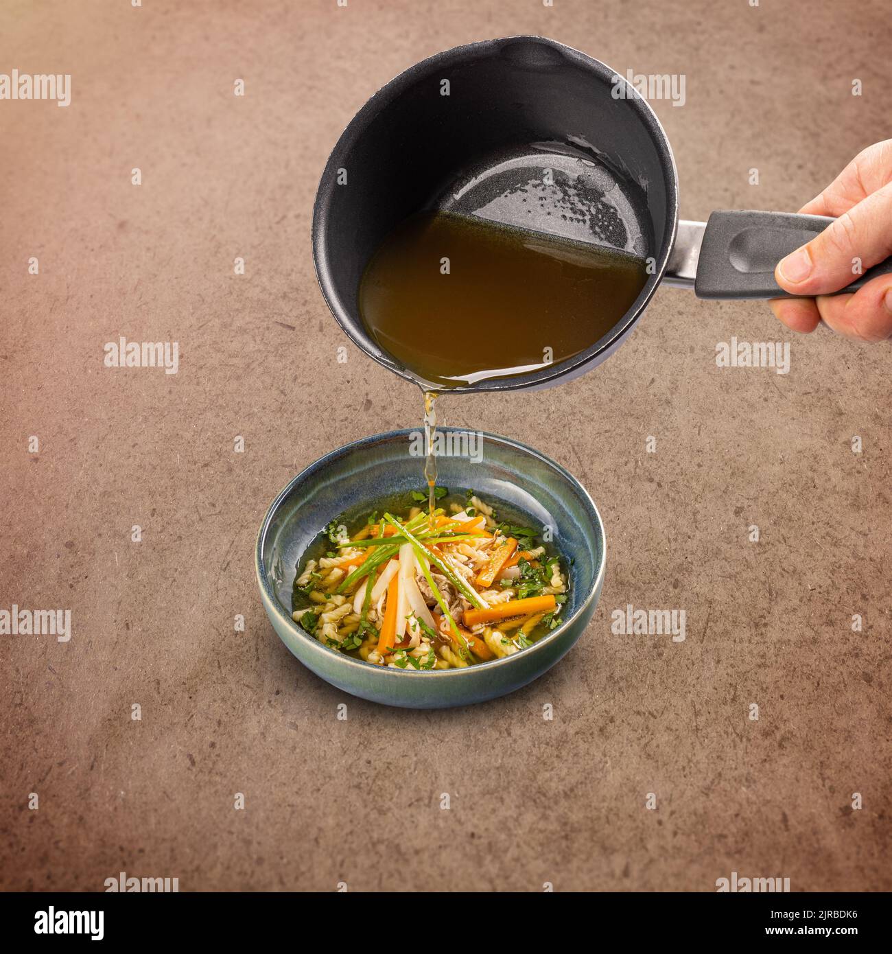 Homemade chicken soup with vegetables, broth pour over vegetables Stock ...