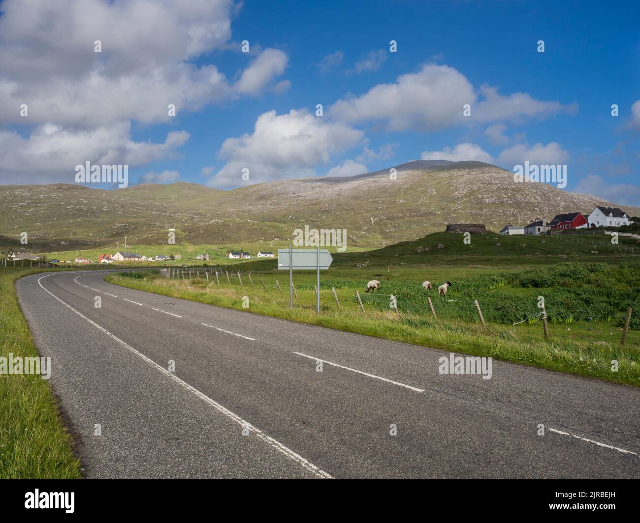 UK, Scotland, Empty asphalt road in Outer Hebrides with hills and ...