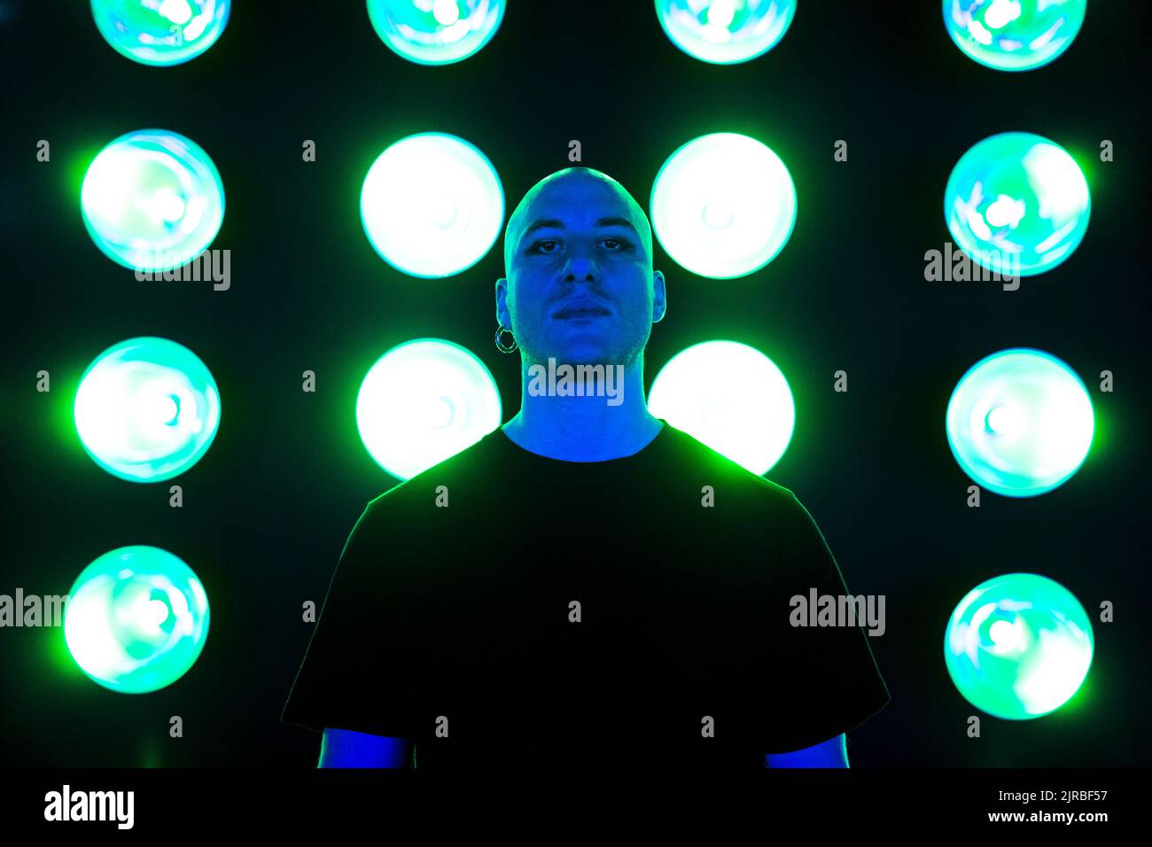 Hipster man in front of illuminated neon lighting Stock Photo - Alamy