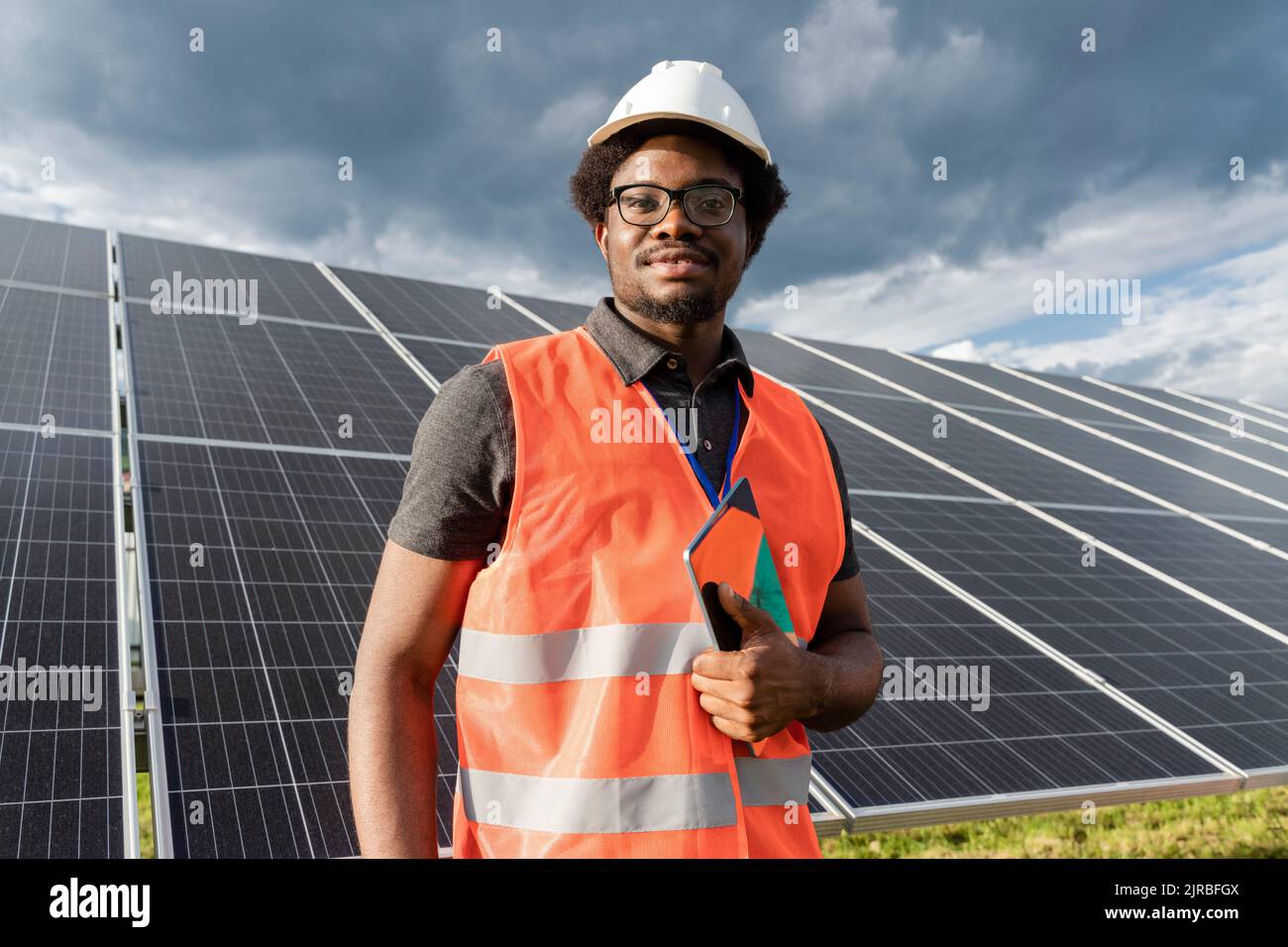 Engineer holding tablet PC at solar station Stock Photo - Alamy